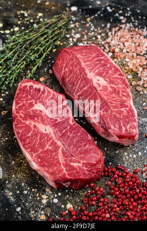 Raw Shoulder Top Blade cuts, beef meat steaks. Brown background. Top ...