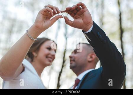 Shallow focus of newlyweds showing their rings Stock Photo - Alamy