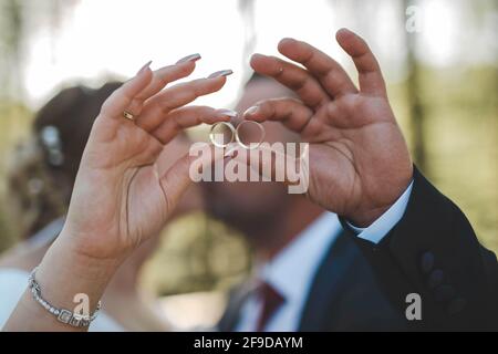 Shallow focus of newlyweds showing their rings Stock Photo - Alamy