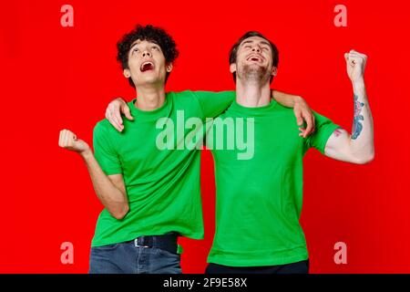 funny friends green t-shirts hugs emotions joy red background Stock ...