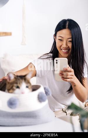 Photo of shiny cute young woman nightwear pink bathrobe talking modern ...