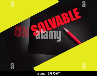 Pencil changing the word Unsolvable into Solvable yellow on black ...
