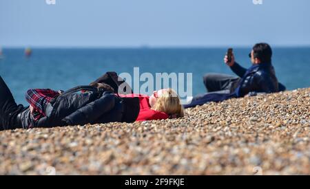 Brighton UK 18th April 2021 - Brighton seafront and beach is busy on a ...