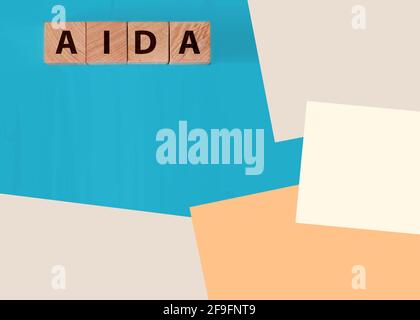 Four wooden cubes with letters AIDA meaning Attention Awareness ...