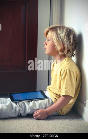 Blond boy with ipad Stock Photo - Alamy