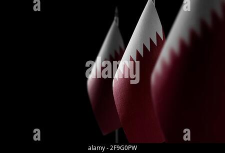 Small national flags of the Qatar on a black background Stock Photo - Alamy