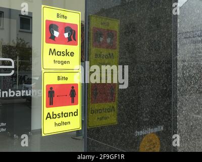 Keep distance wear the mask yellow information sign Stock Photo - Alamy