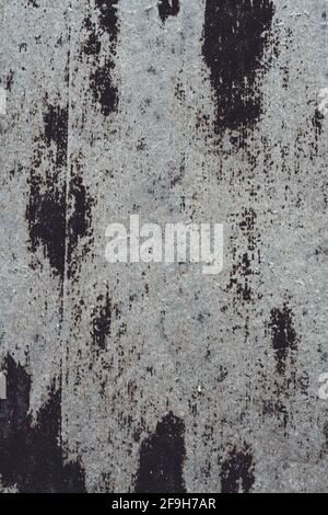 Weathered old dark gray ruberoid texture with numerous cracks and ...
