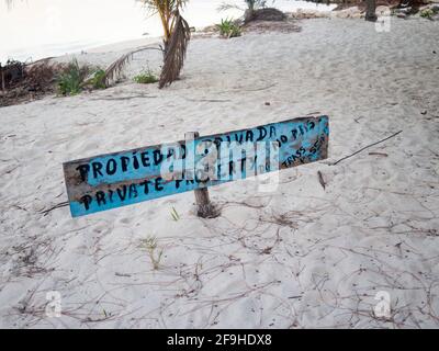 A "Private Property" sign on a beach in Europe. Focus on sign with ...