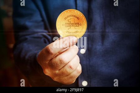 Tether USDT stablecoin cryptocurrency golden coin in hand abstract ...
