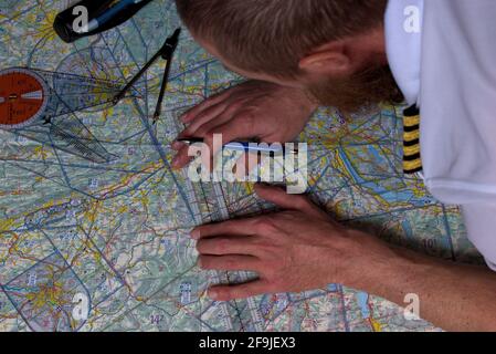 Pilot is calculating his navigation route on an actual map 25.3.2021 ...