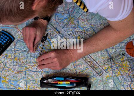 Pilot is calculating his navigation route on an actual map 25.3.2021 ...