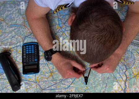 Pilot is calculating his navigation route on an actual map 25.3.2021 ...