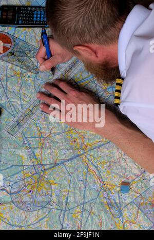 Pilot is calculating his navigation route on an actual map 25.3.2021 ...