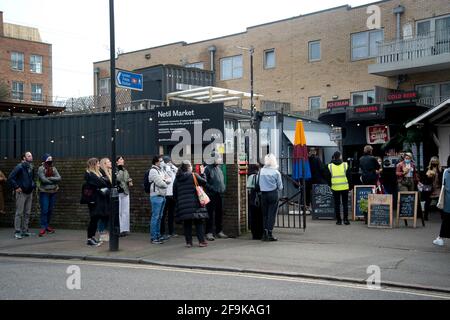 London, England, UK. Hackney. Netil Market. Queue of people waiting to ...