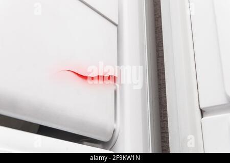 Crack on the polystyrene lid of the refrigerator freezer, close-up. The ...