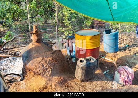 Distillation setup where cashew juice extract is distilled to form ...