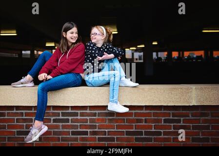 two tween girls friends talking together outdoor Stock Photo - Alamy