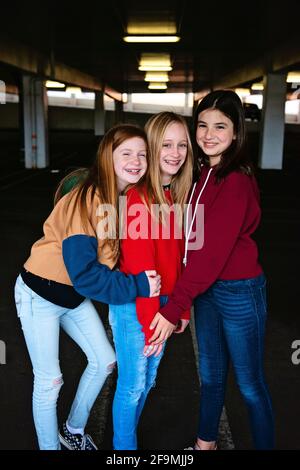 Three cute and happy tween girls standing together Stock Photo - Alamy