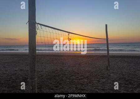 Volleyball court without players at sunrise Stock Photo - Alamy