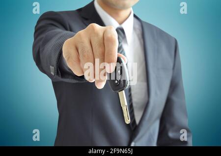Businessman hand giving a car key - car rental & pawn concepts Stock ...