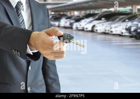 Businessman hand giving a car key - car rental & pawn concepts Stock ...