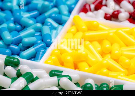 Medication capsules in green and yellow colors Stock Photo - Alamy