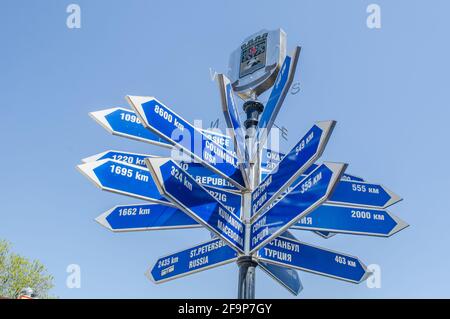 Directional sign showing distance to major cities around the world ...