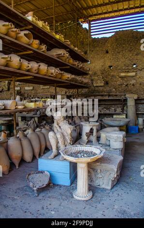 detail of a petrified corpse inside of area of ruins of the pompeii ...