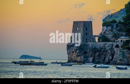 many small boats are anchoring in front of italian city positano during ...