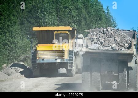 Juggernaut. Pit dump truck, large-capacity dump truck rides on a gravel ...