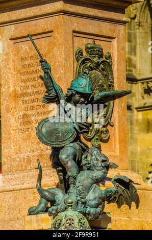 Bronze statue of a man killing a dragon at night, part of the ...