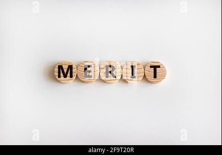 Merit symbol. Wooden circles with the word 'merit'. Beautiful white ...