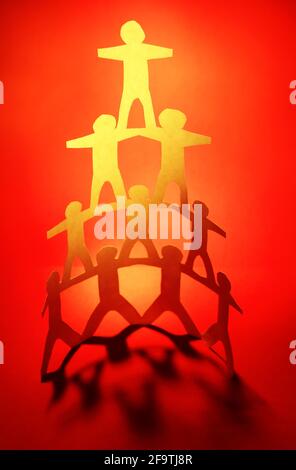 Human team pyramid supporting each other Stock Photo - Alamy