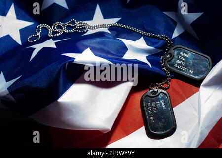 Army tokens on American national flag background Stock Photo - Alamy