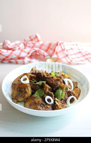 Mutton ghee roast. Goat meat fry with potatoes, also known as Mutton ...
