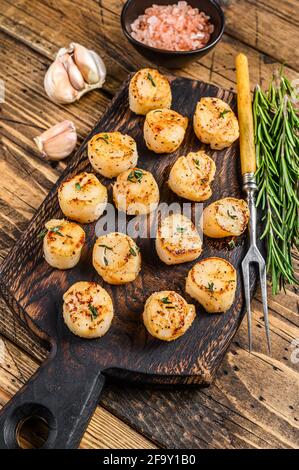 BBQ Seared scallops with butter sauce on a wooden board. wooden ...