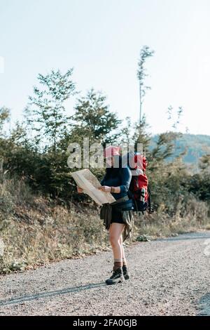 woman hiker checking map and directions Stock Photo - Alamy