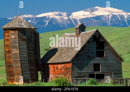 old barn and silo below the beartooth mountains near boyd, montana ...