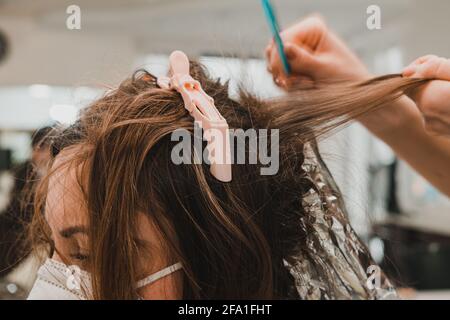 Hair coloring during the quarantine period, client and hairdresser in ...