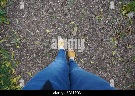 Foot and legs seen from above. Selfie of feet in fashion black sneakers ...