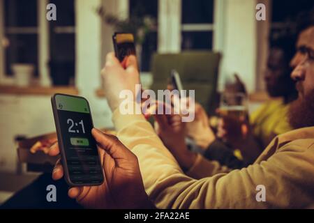 A group of friends cheering on their favourite team at the bar Stock ...