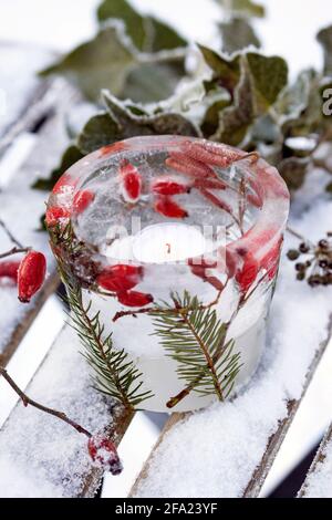 ice lantern, candle burns inside an ice bowl, which is decorated with ...
