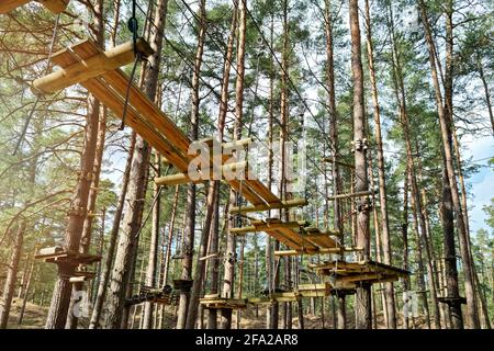 rope obstacle track high in the trees in adventure park Stock Photo - Alamy