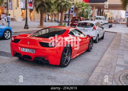 Dubai, UAE - November 20, 2013. Red Ferrari driving in Dubai Maria ...