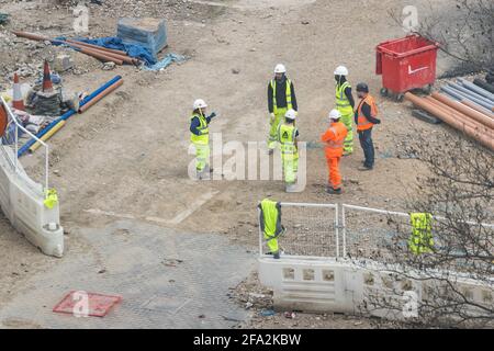 Construction building industry site workers below diagonal shoring ...