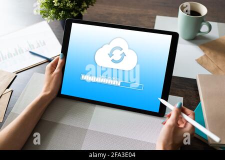 Cloud synchronization progress bar on tablet screen. Data storage and ...