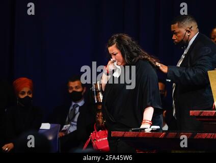 A police officer wipes away tears amid mourners during the join funeral ...