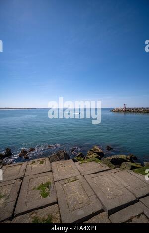Vertical shot of breakwall and immense rock formations on coastline ...