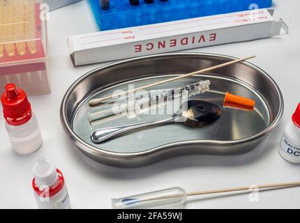 Syringe and spoon in police drug investigation department, concept ...